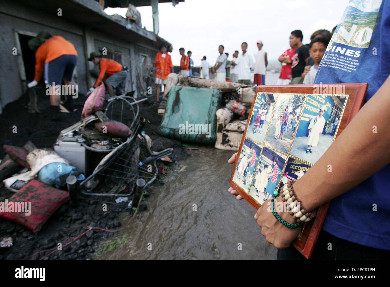 Joyada Redoblado, right, clutches laminated photos of his missing aunt ...