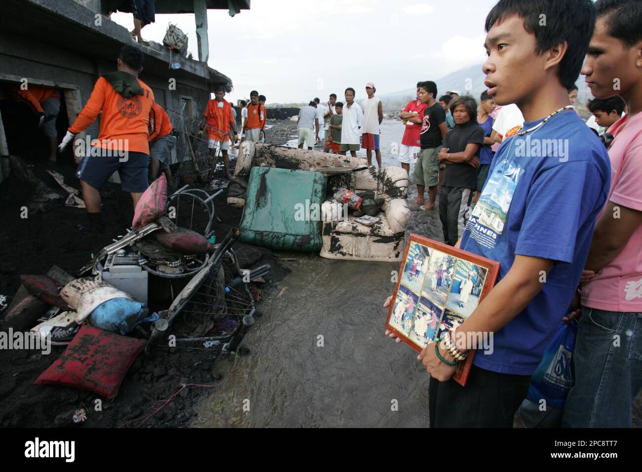 Joyada Redoblado, second from right, clutches laminated photos of his ...