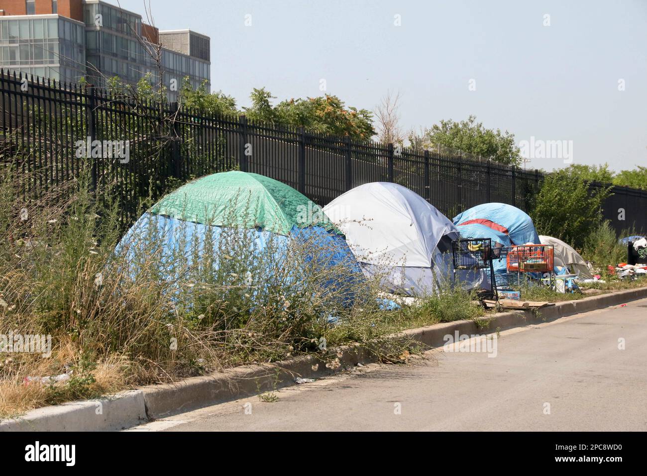 A homeless encampment has sprung up along a highway exit ramp in the ...