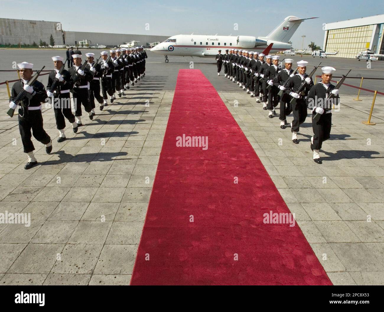 A Mexican navy honor guard marches on the tarmac as the aircraft ...