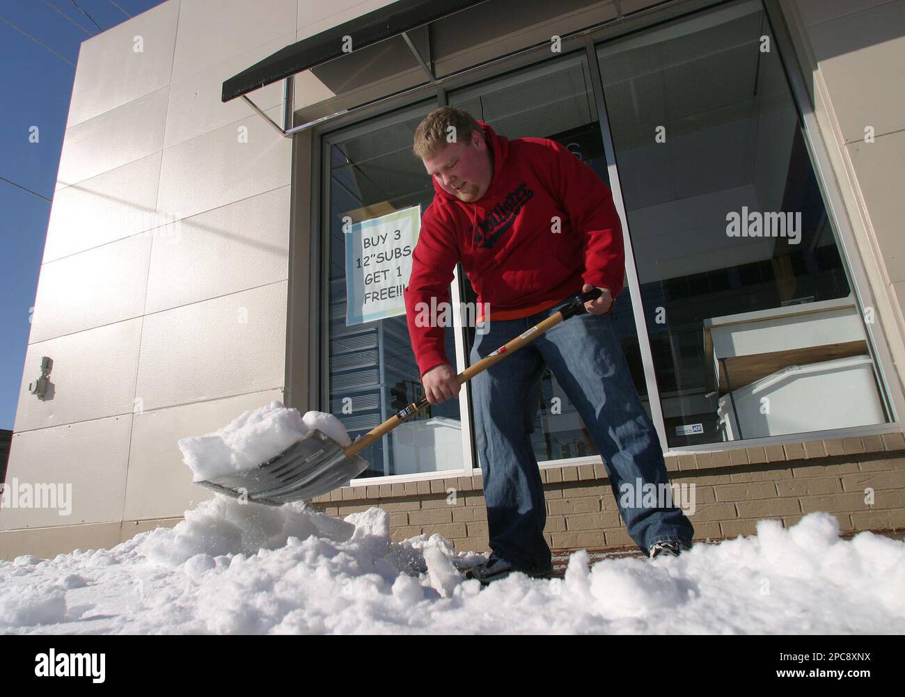 Manager Darren Green of Springfield, Mo., shovels the sidewalk outside ...