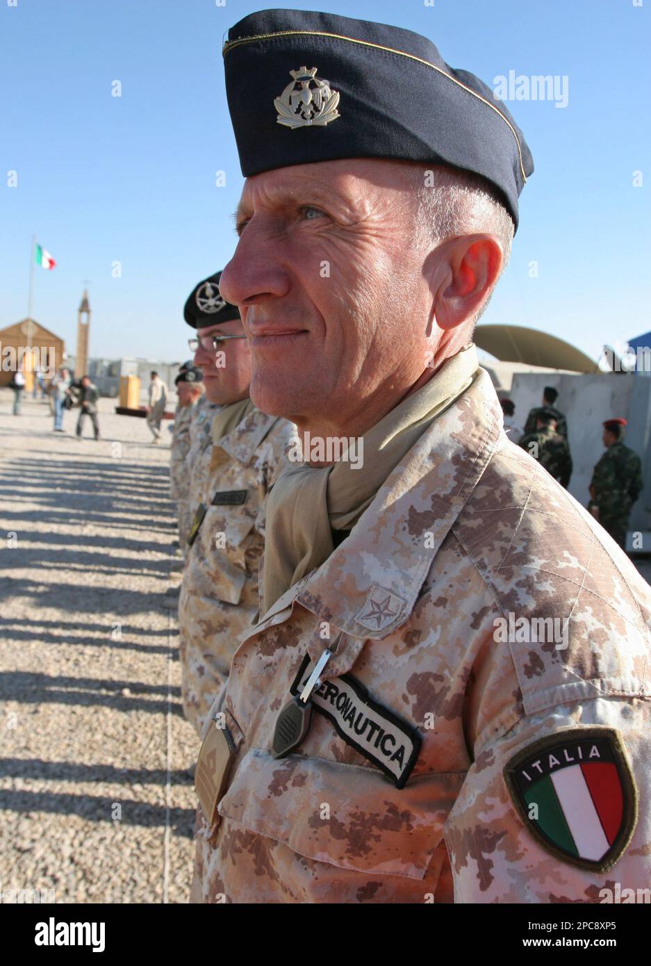Italian military personnel stand guard at a military base in Nasiriyah ...