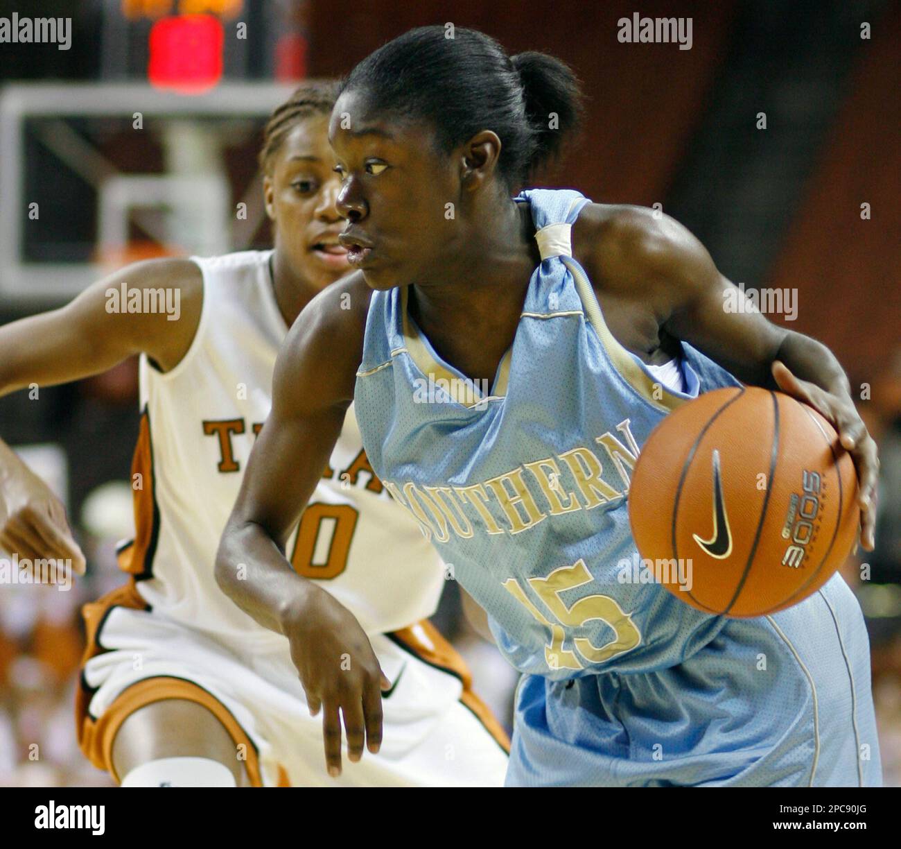 Southern guard Aerica Hicks, right, moves past the defense by Texas ...