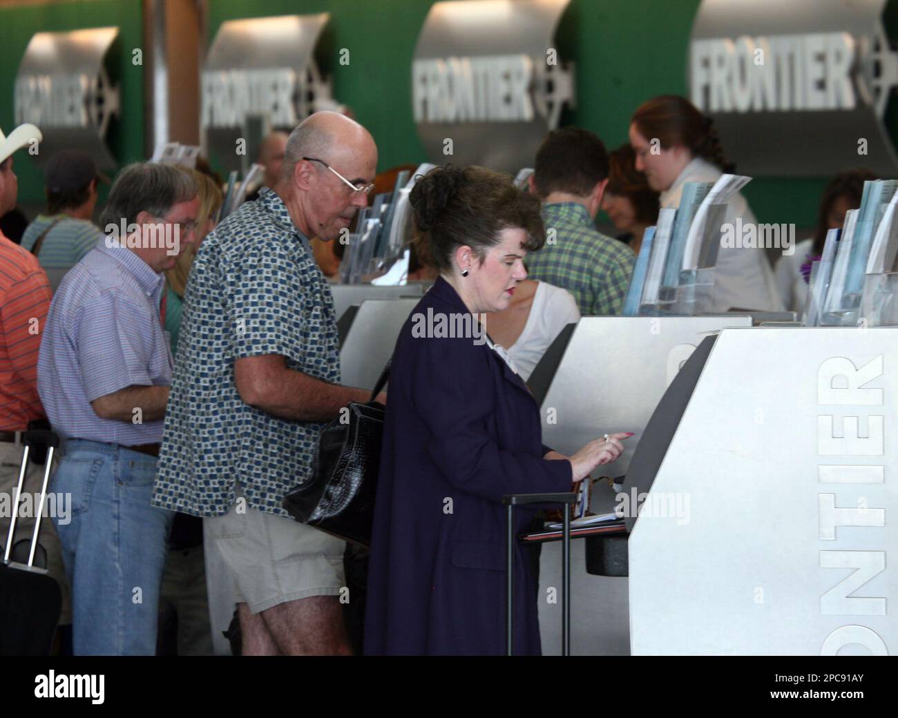 ** FILE **Passengers use the self check-in kiosks at the counter of ...