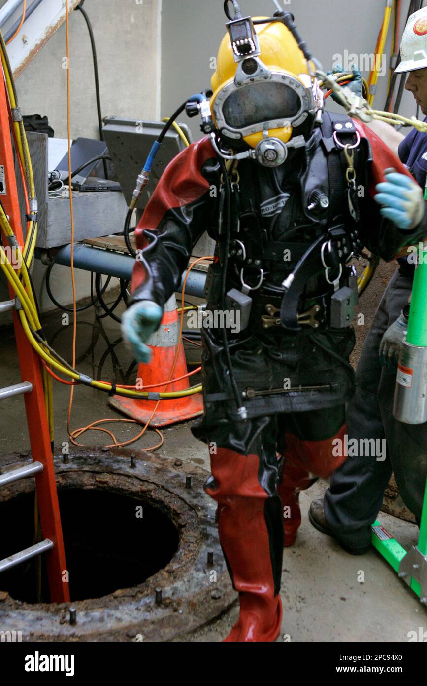 A diver, who did not wish to be identified, exits a giant pipe that ...