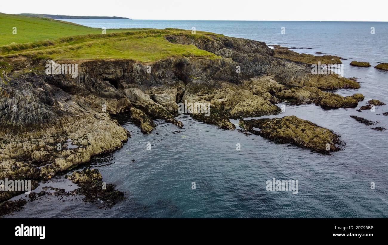A rocky cape on the Atlantic coast of Ireland. Seaside landscape. Green ...