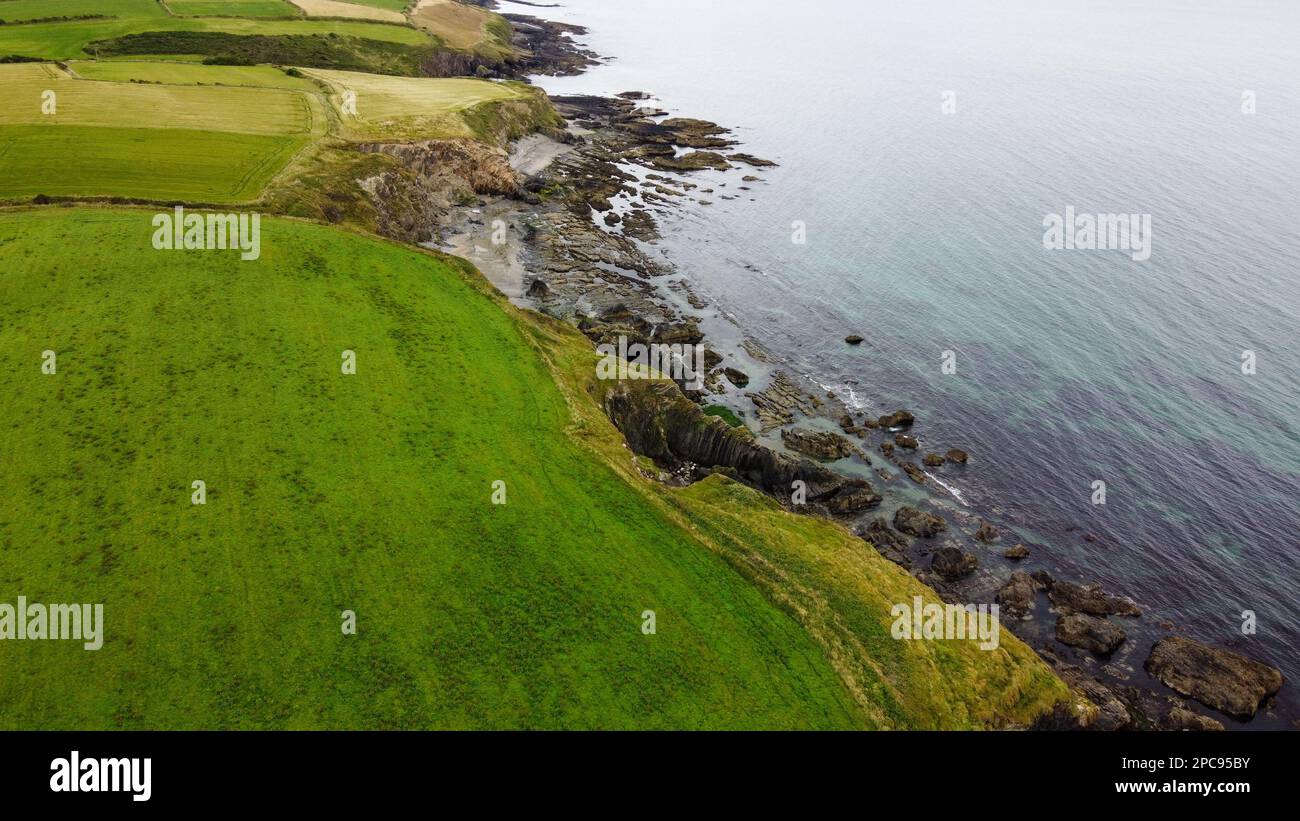 Rocky coast. Green farm fields on the Atlantic Ocean. Seaside Irish ...