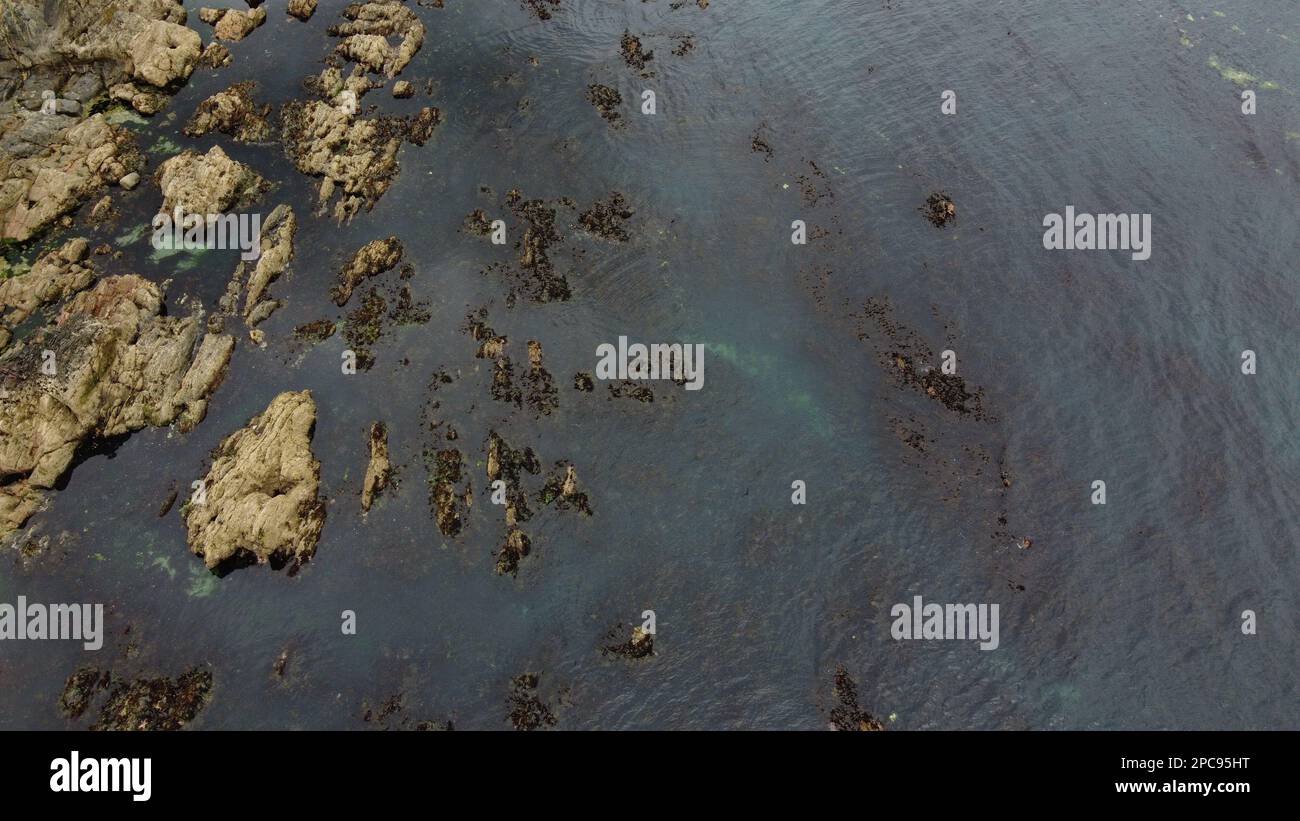 Rocky seashore, top view. Big rocks in the water Stock Photo - Alamy