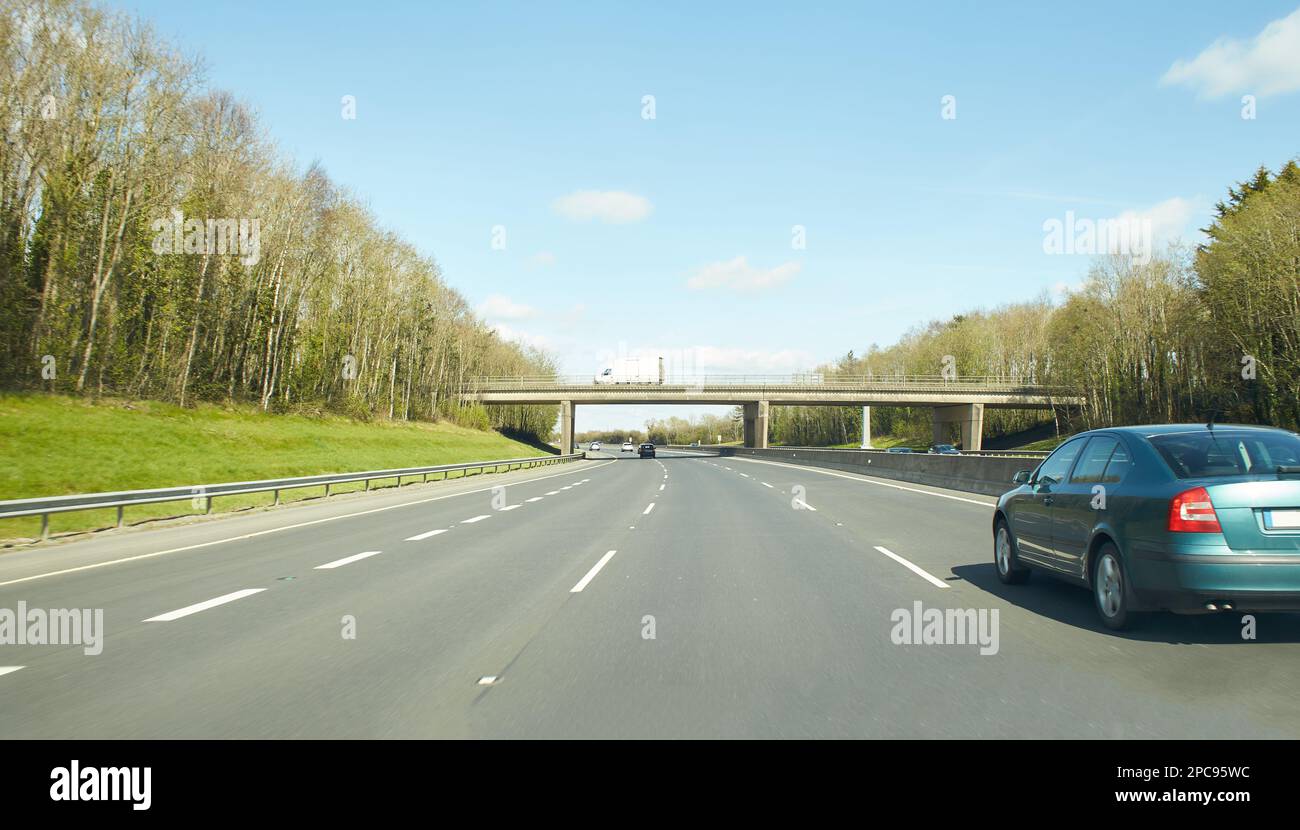 Rear view of cars driving on motorway, Ireland. Road with metal safety ...