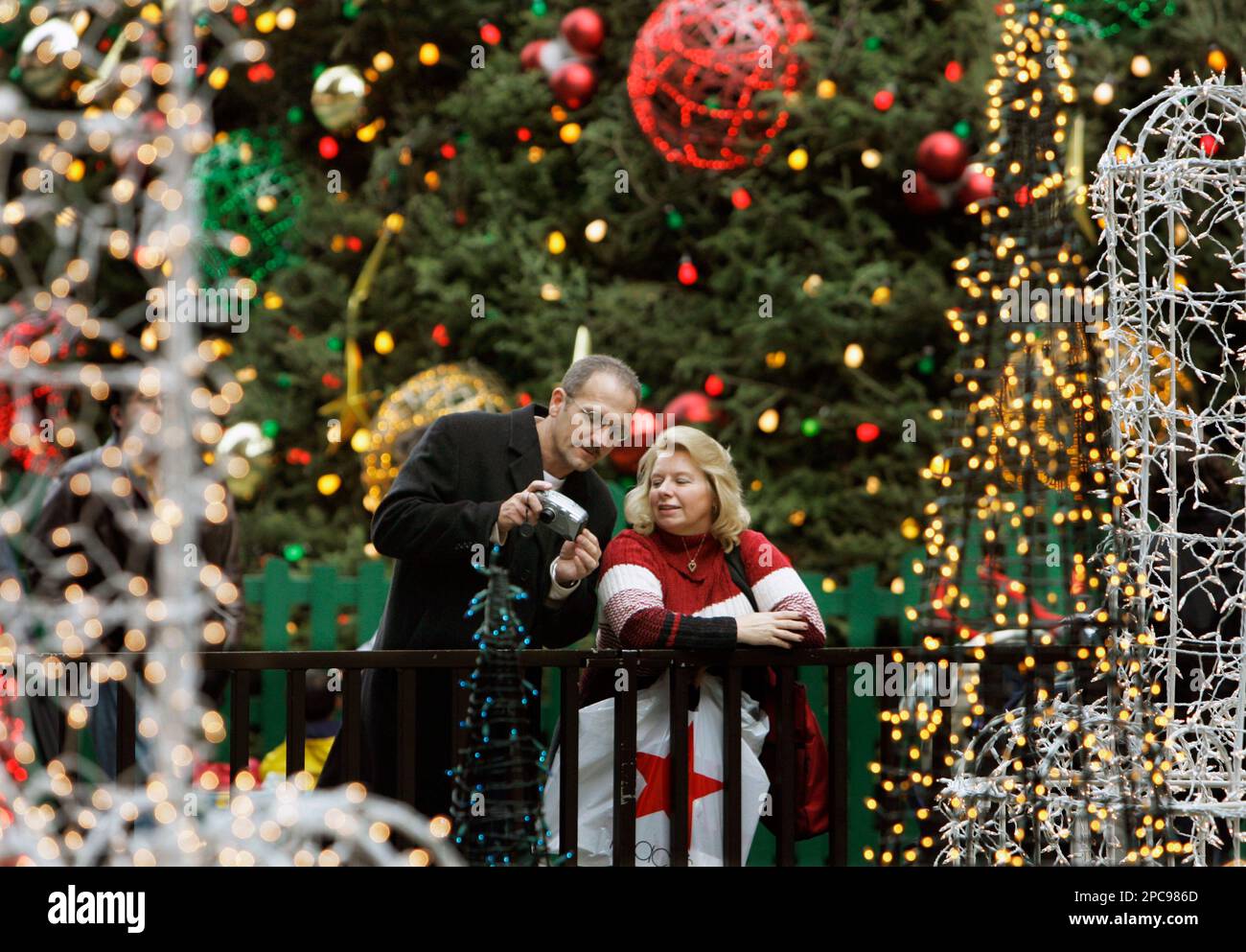 Shoppers take photos of the light displays at Christkindlmarket Chicago ...