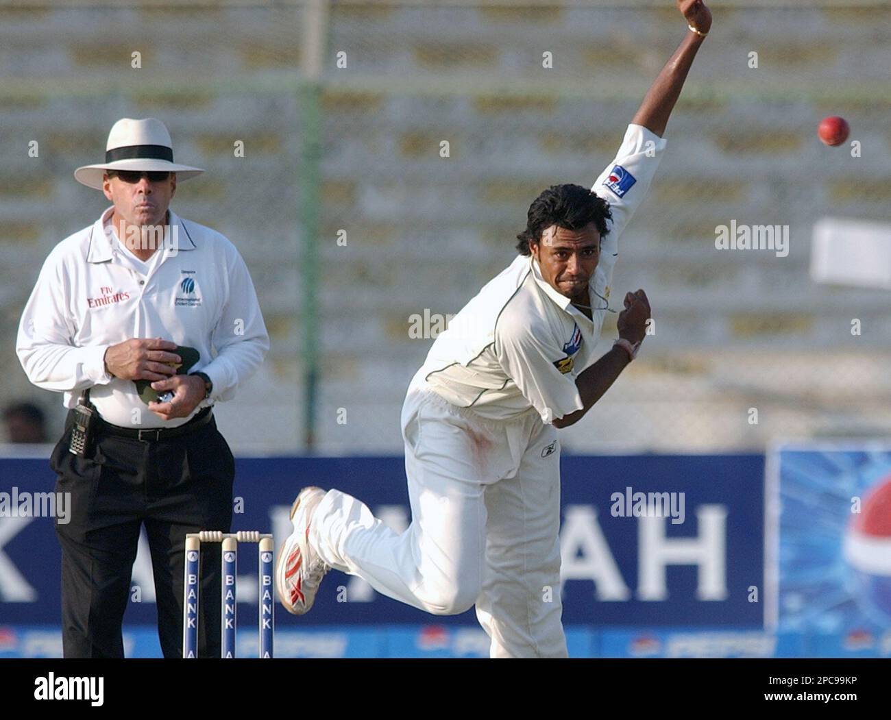 Pakistani spinner Danish Kaneria delivers a ball as Australian umpire ...