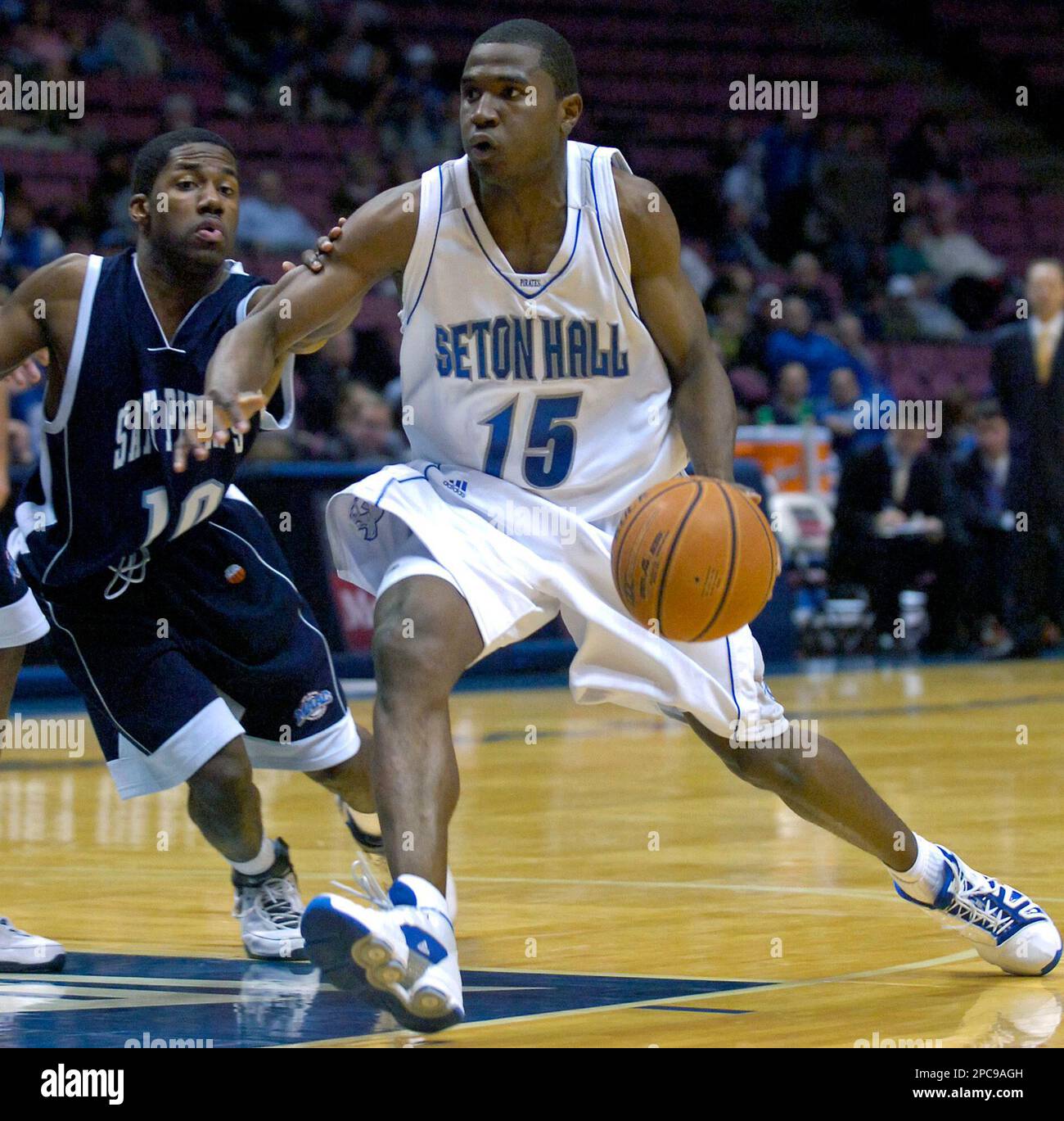 Seton Hall's Eugene Harvey (15) drives to the basket as he is guarded ...