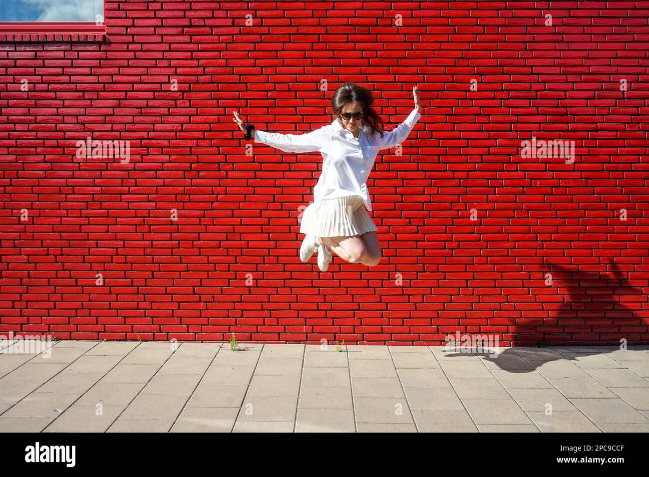 Portrait happy young woman jumping building hi-res stock photography ...