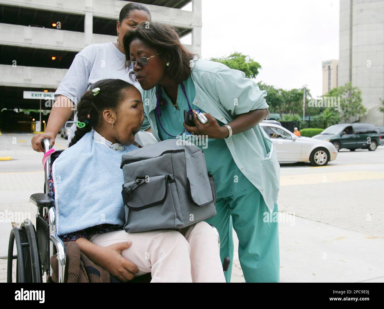Marlie Casseus, left, is kissed by nurse Jessie Darius, right, as she ...