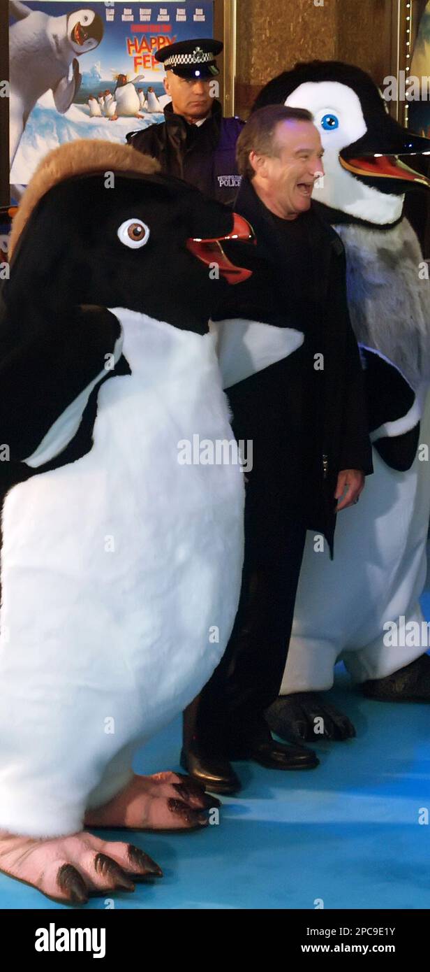 U.S. actor Robin Williams poses with two penguins in Leicester Square ...