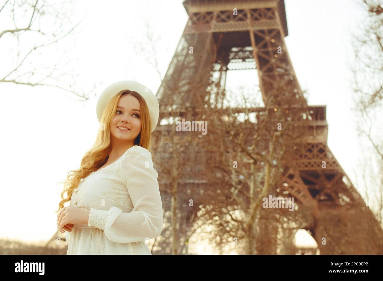 Beautiful blonde in Paris with the Eiffel Tower in the background in a ...