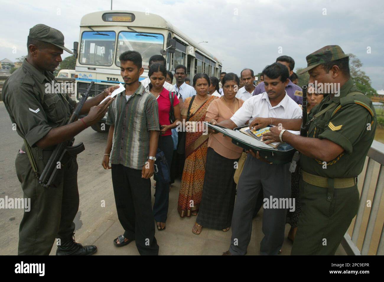 Sri Lankan government soldiers inspect the identity of commuters at a checkpoint in Colombo, Sri ...