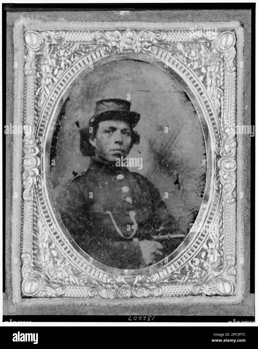 Black soldier seated with pistol in hand, watch chain in pocket. Black ...