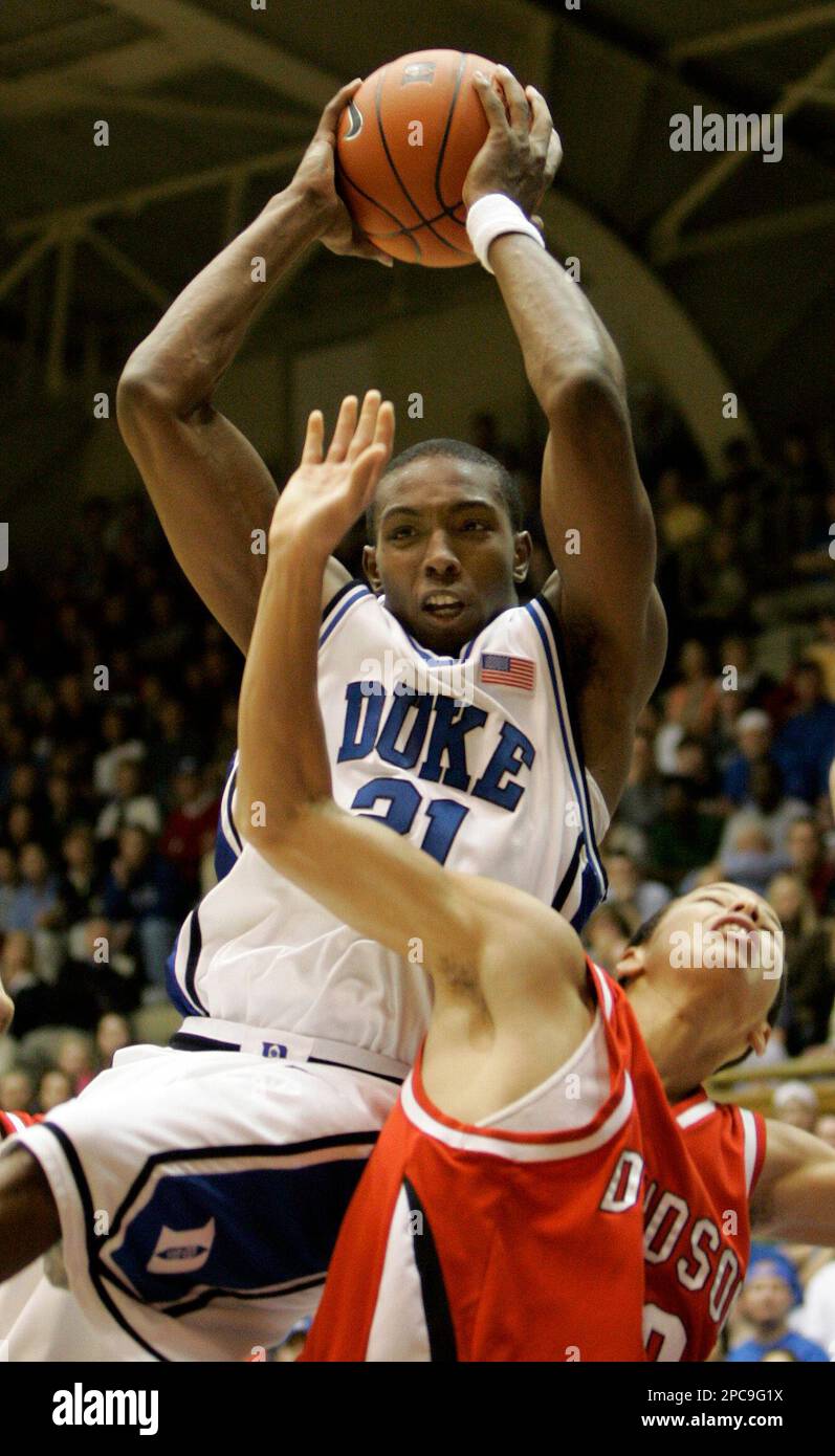 Duke's DeMarcus Nelson, top, drives to the basket as Davidson's Stephen ...