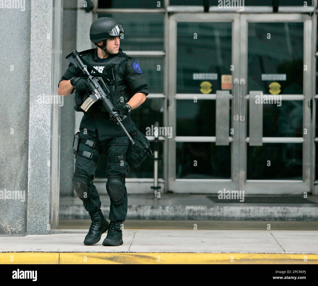 A member of the Miami SWAT team leaves the Miami Herald building Friday ...