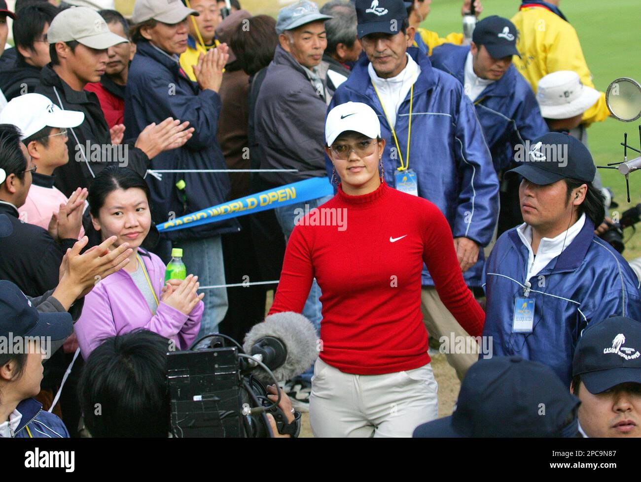 Michelle Wie of the U.S. walks past Japanese fans after finishing the ...