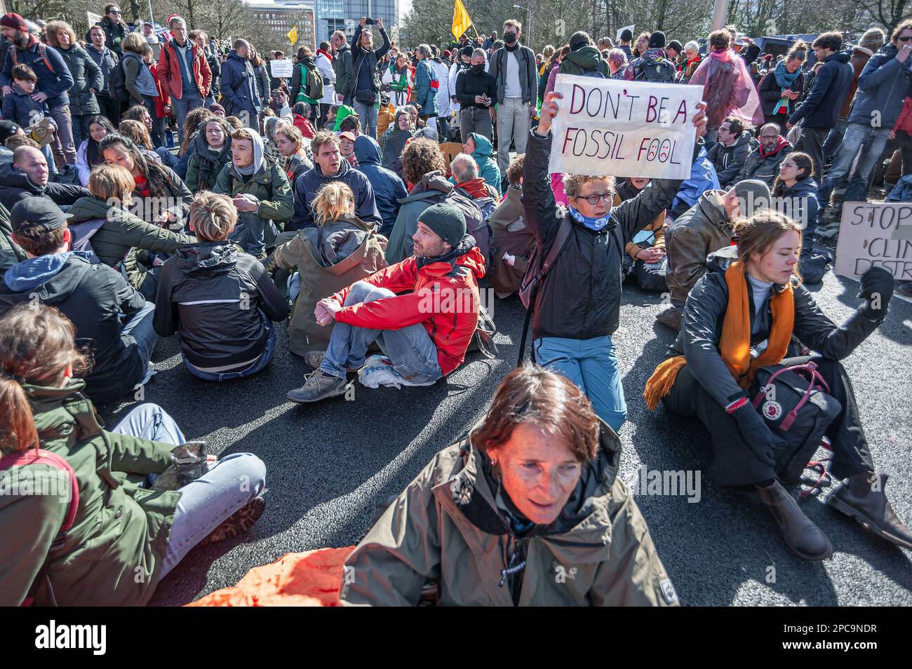 An activist holds a placard that reads ‘DON'T BE A FOSSIL FOOL' during ...