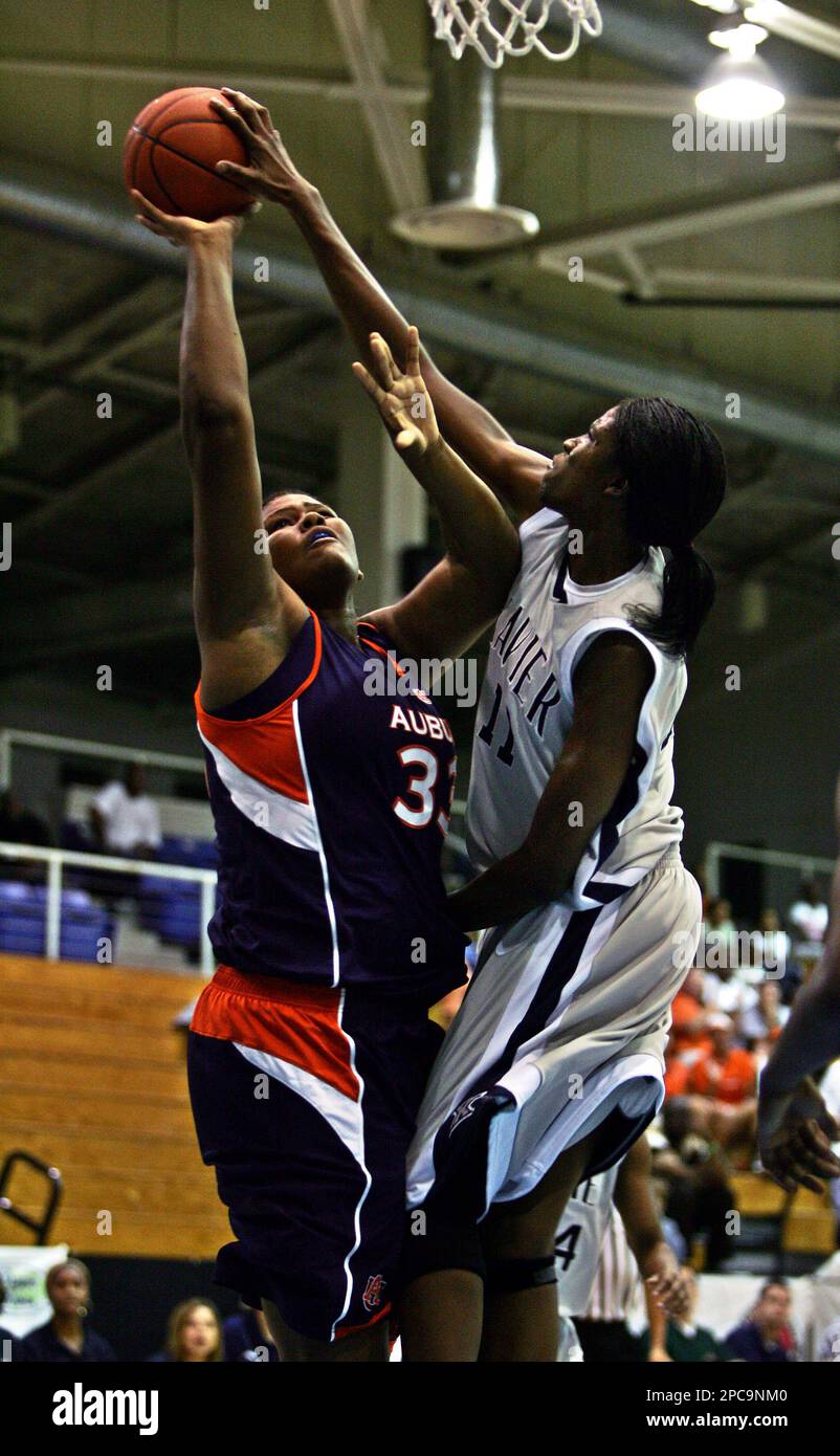 Auburn's Keke Carrier, left, has her shot blocked by Xavier's Amber ...