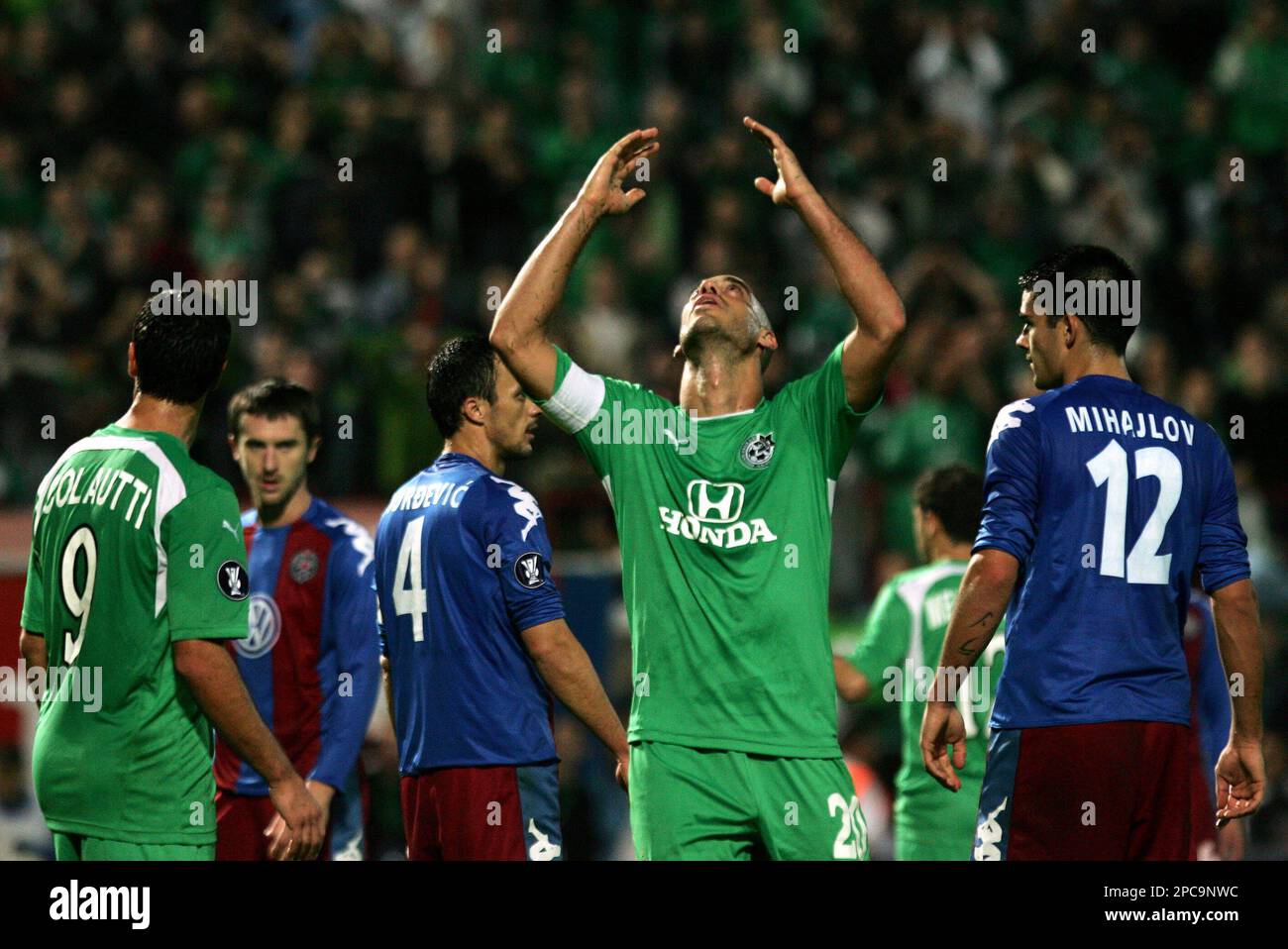 Maccabi Haifa's captain Yaniv Katan, center, reacts after missing a ...