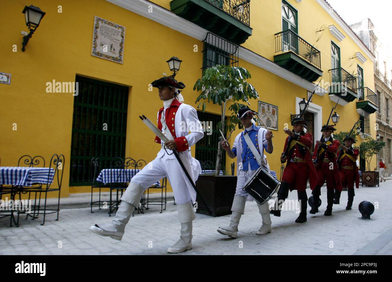Cuban militaries dressed as historical Spanish soldiers march through a ...