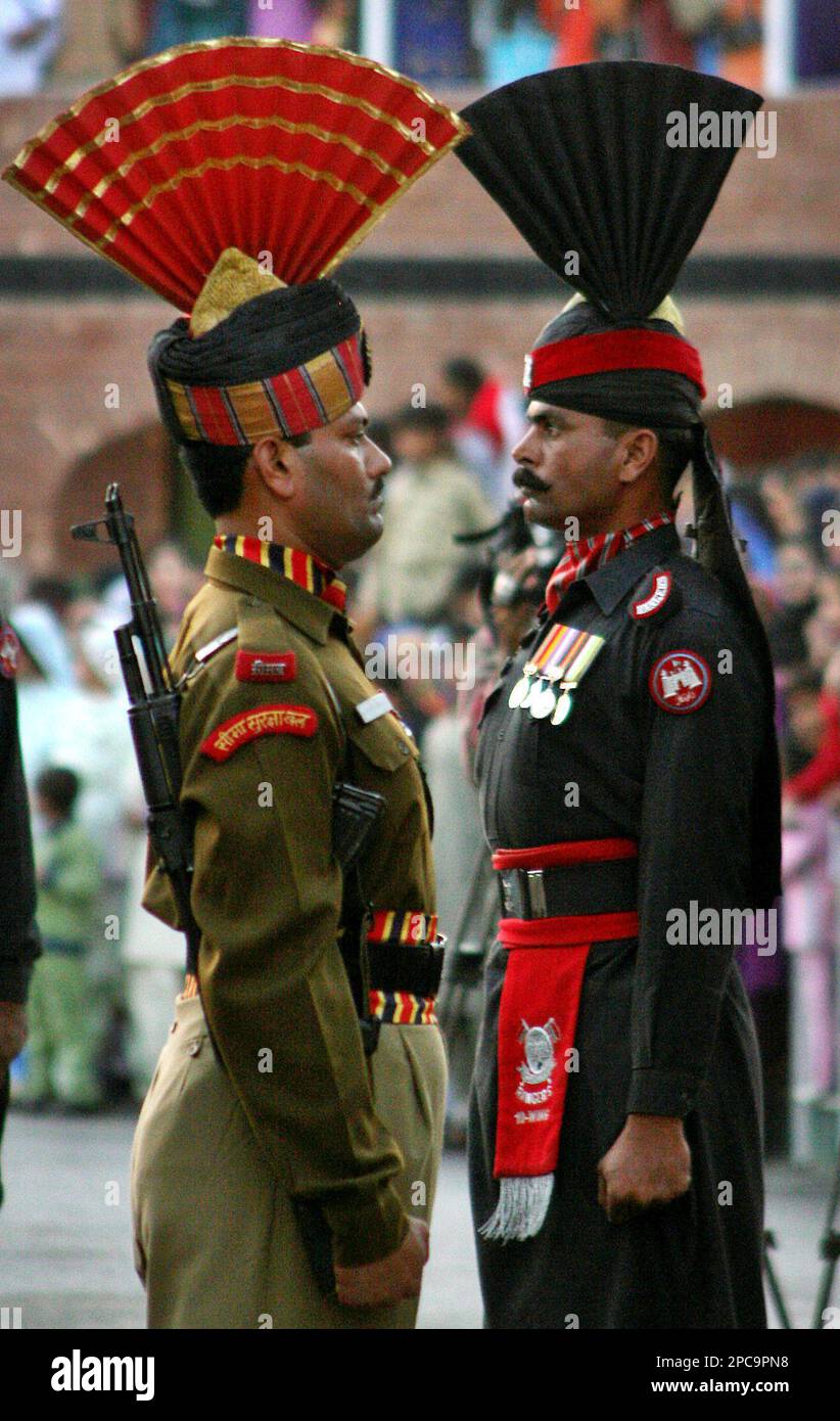 An Indian Border Security Force soldier, left, and a Pakistani Rangers ...