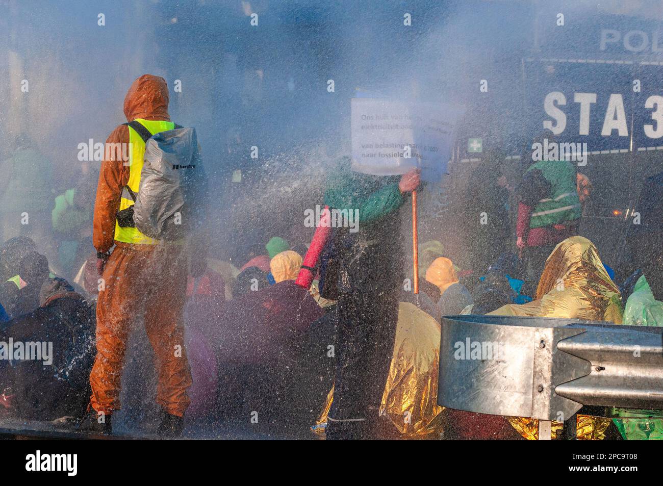 A water cannon truck shoots water towards protesters during the ...