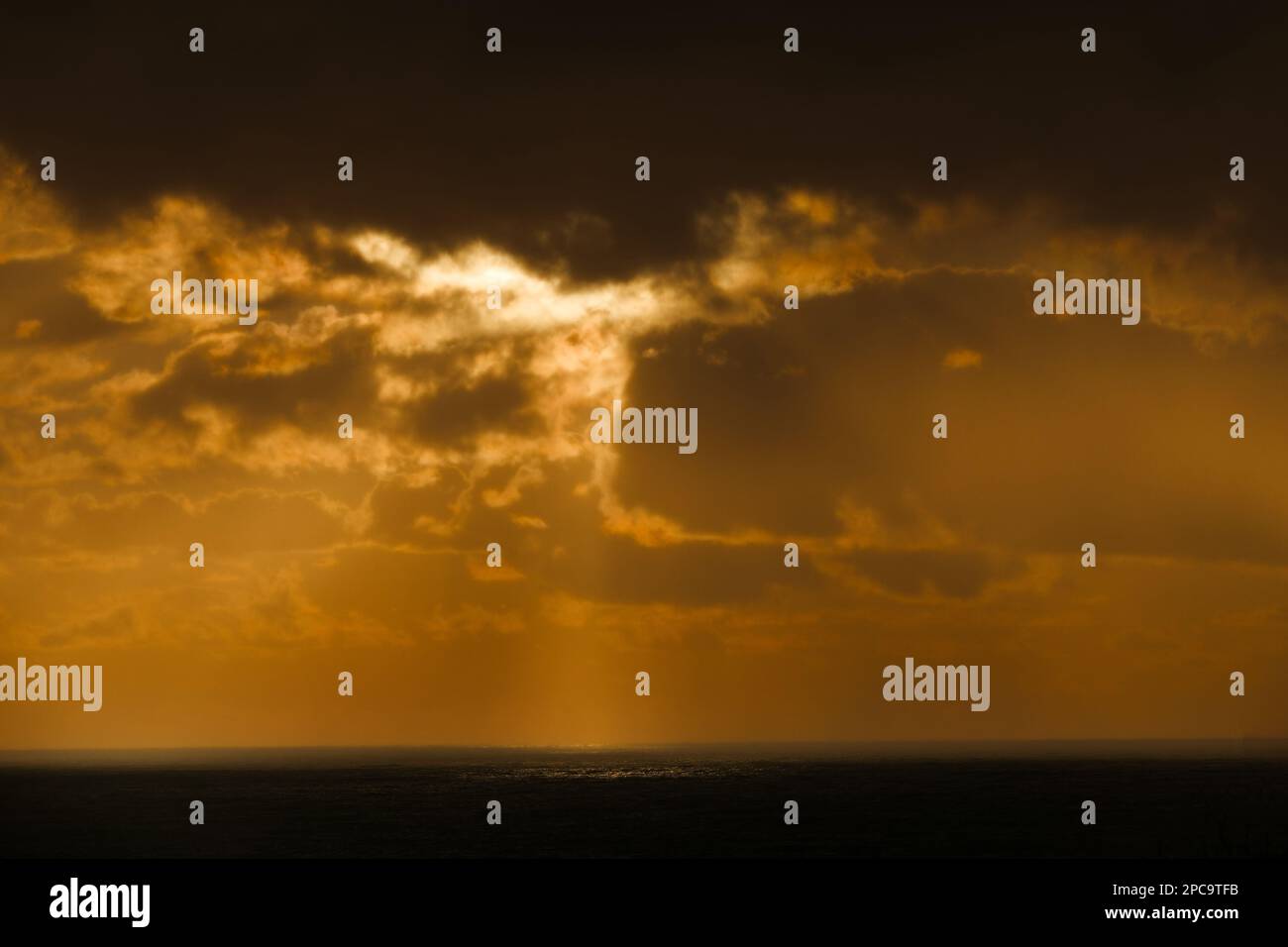 The sun's rays fall on the surface of the sea through the clouds. Not dense rain clouds Stock ...