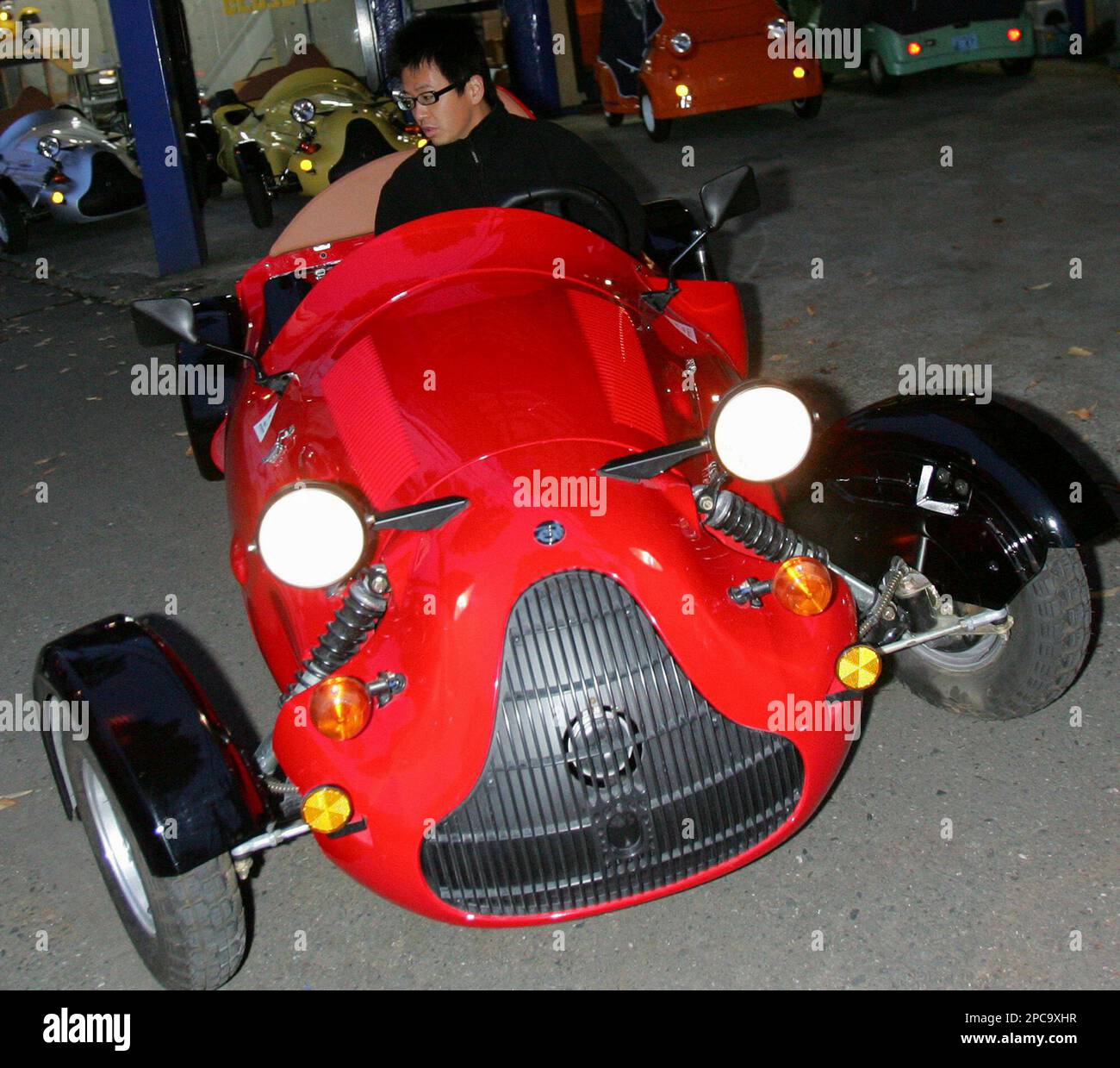 Japan's independent automaker Mitsuoka Motor Co.'s employee sits behind ...