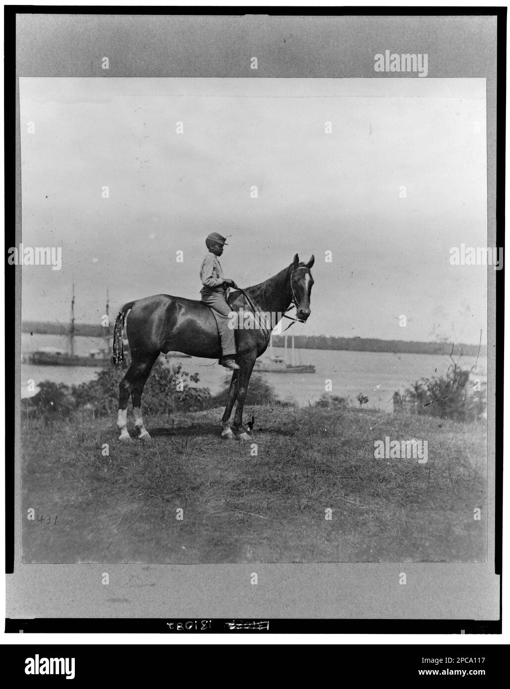 African American boy seated on a horse near a river. No. 2431, Caption ...