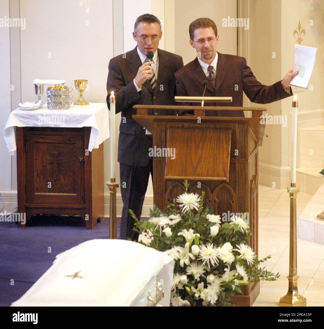 From left, David Ponce Deleon, and Brian Baughman read from the journal ...