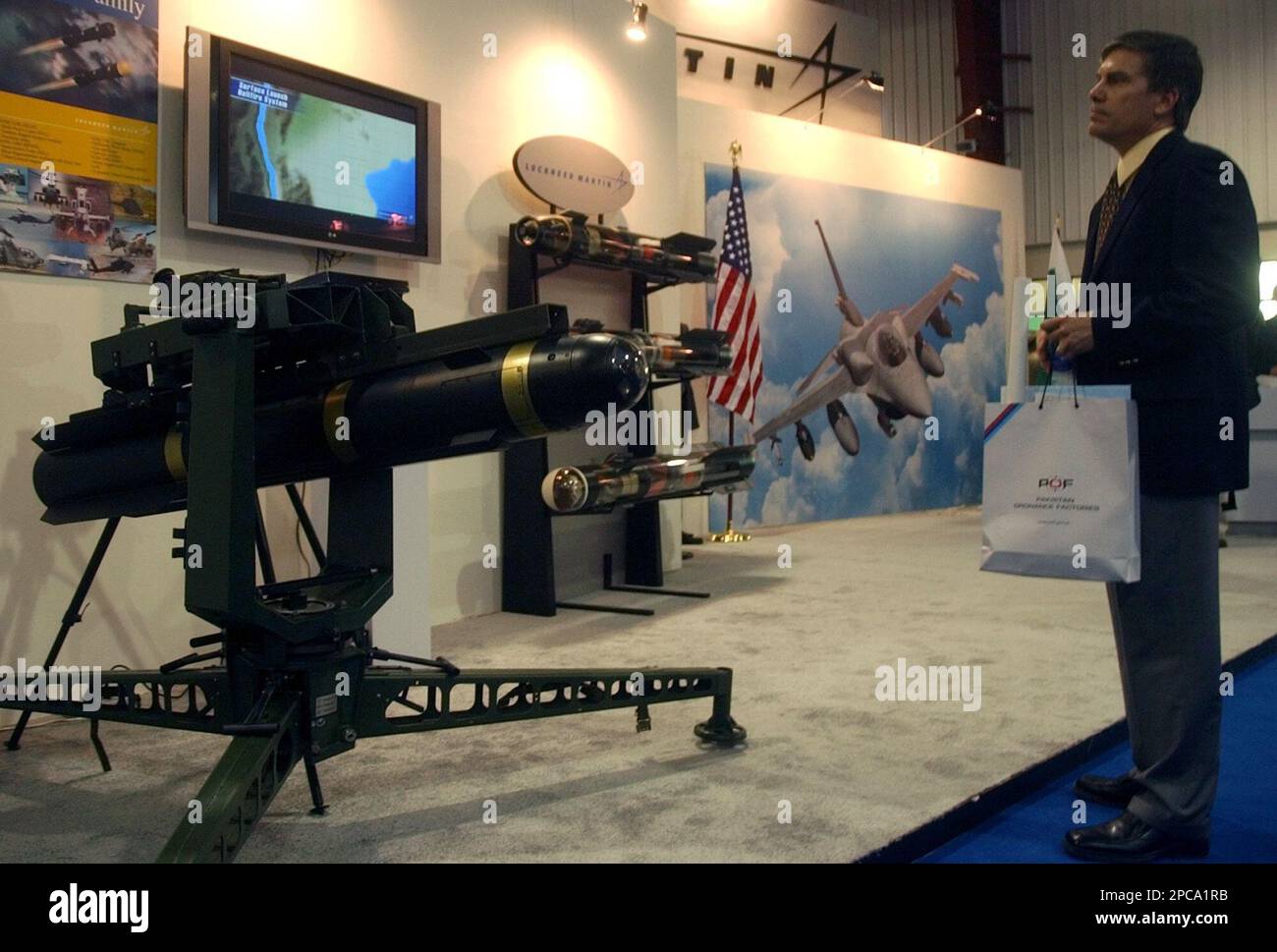 A visitor reviews the stall of a U.S. company Lockheed Martin at IDEAS ...