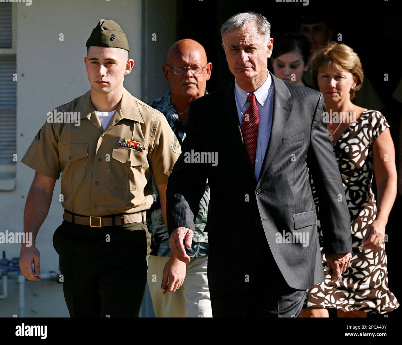 Marine Corps Lance Cpl. Robert Pennington, left, arrives with his ...