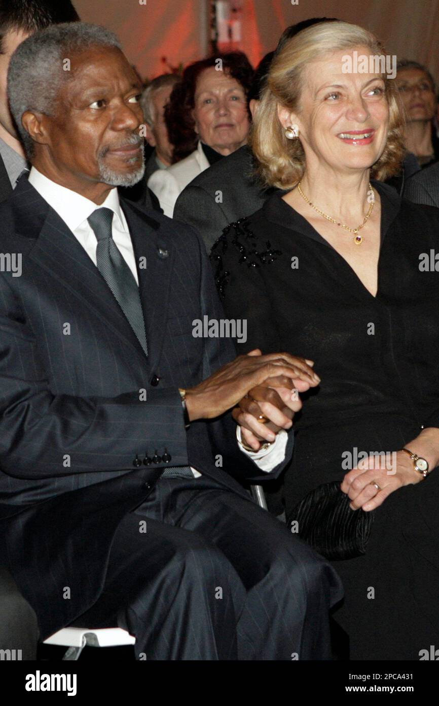 United Nations Secretary General Kofi Annan, left, holds the hand of ...