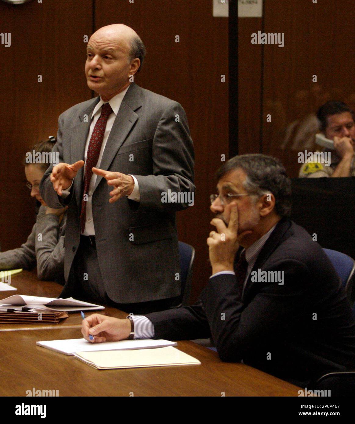 Defense lawyer Mark Overland, left, delivers a motion as Mark ...