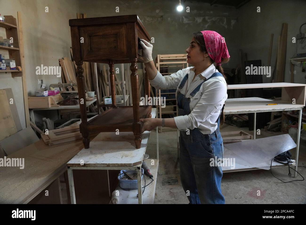 Iranian carpenter Sahar Biglari paints a product at her workshop in ...