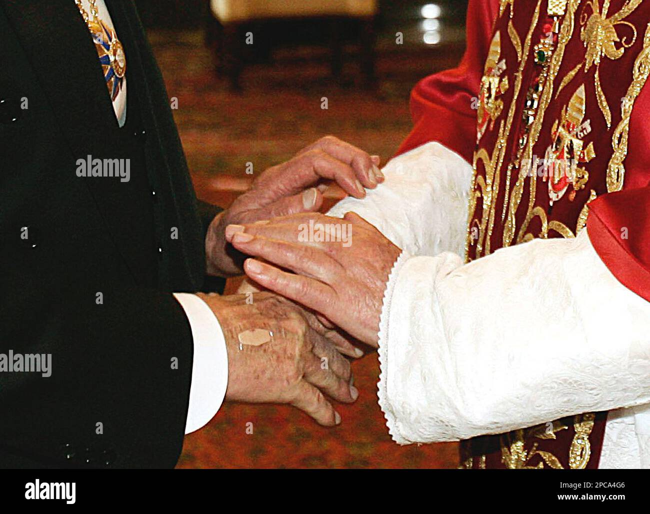 ** RECROP ** A close-up of the handshake between Pope Benedict XVI ...