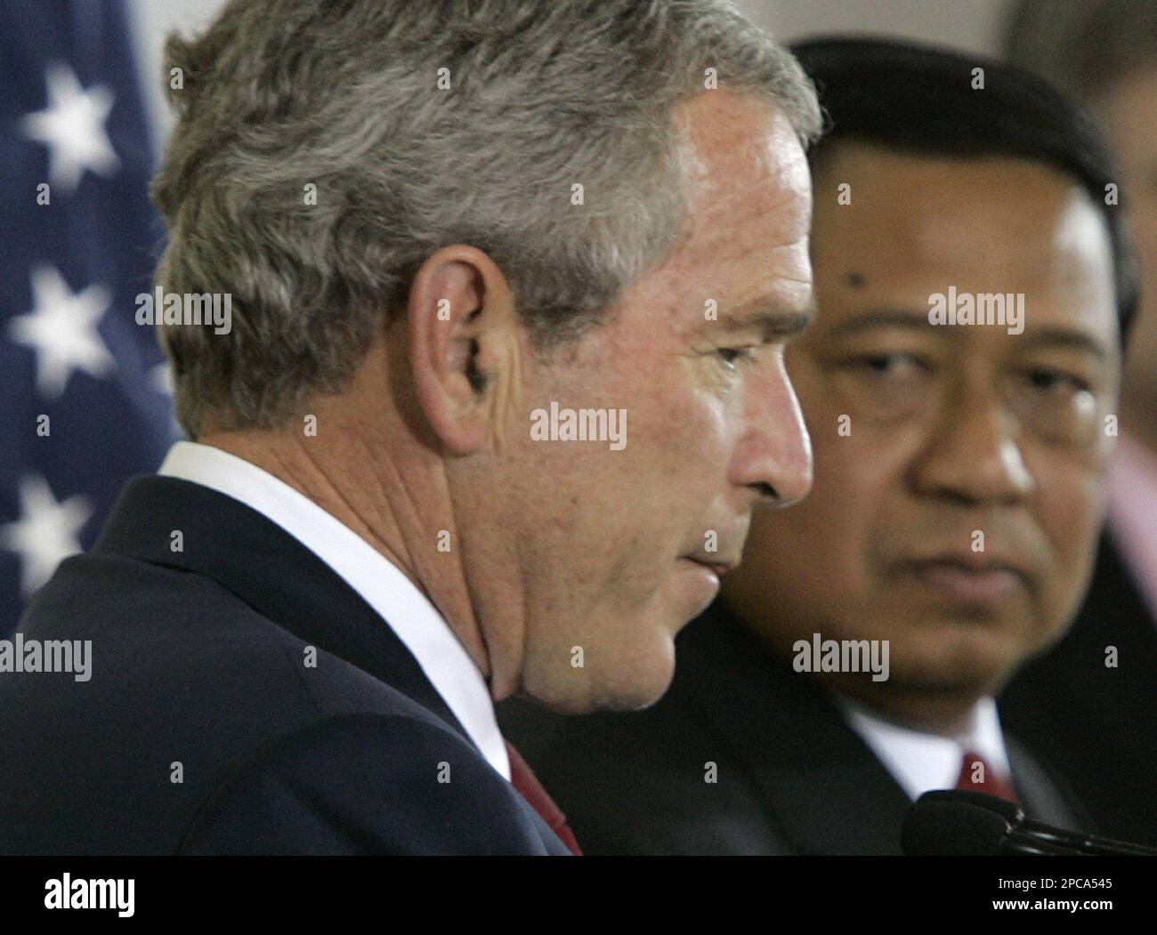 President Bush, left, speaks during a joint press conference as ...