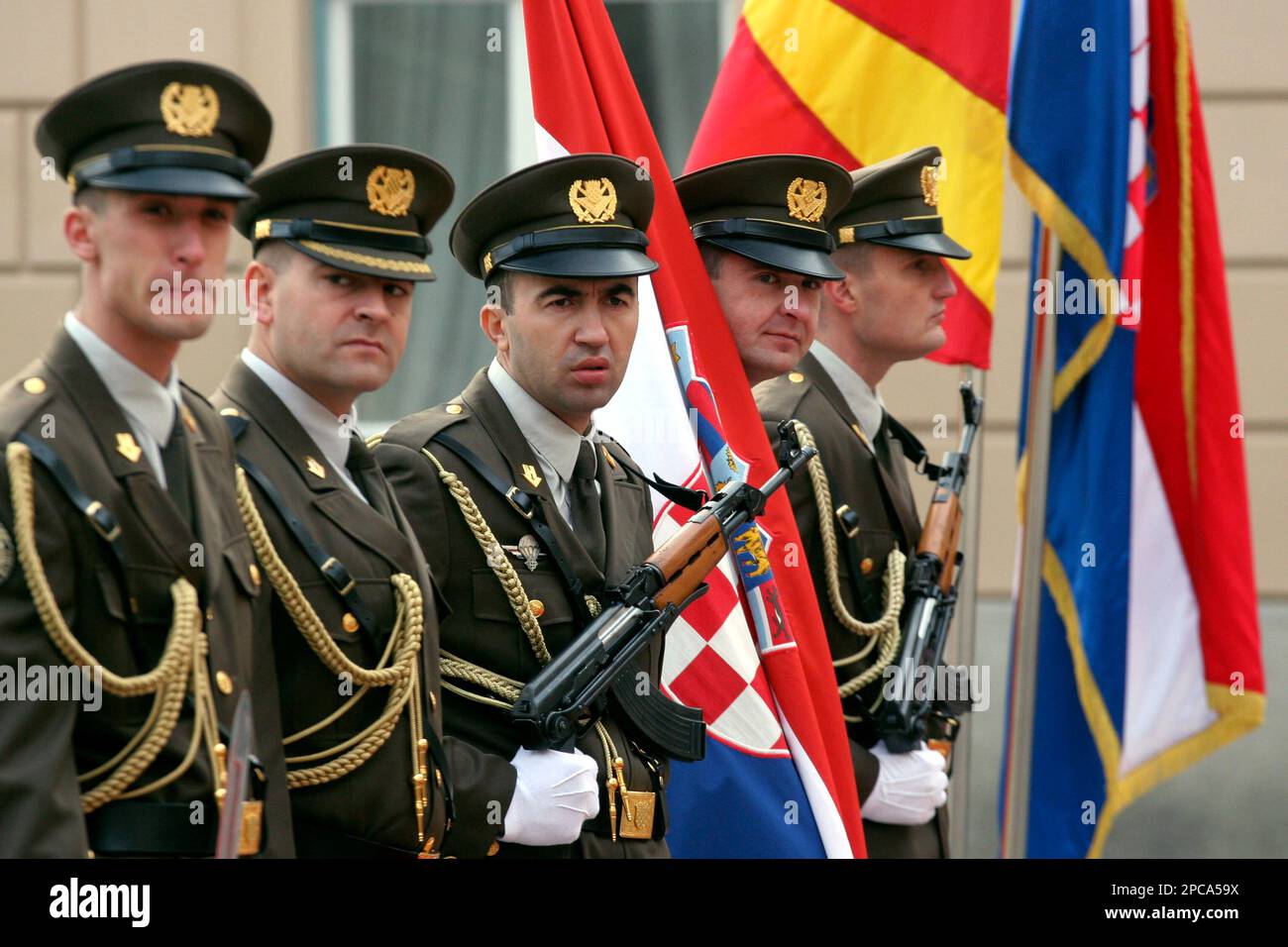 The Croatian guard of honor waits between Croatian and Macedonian flags ...