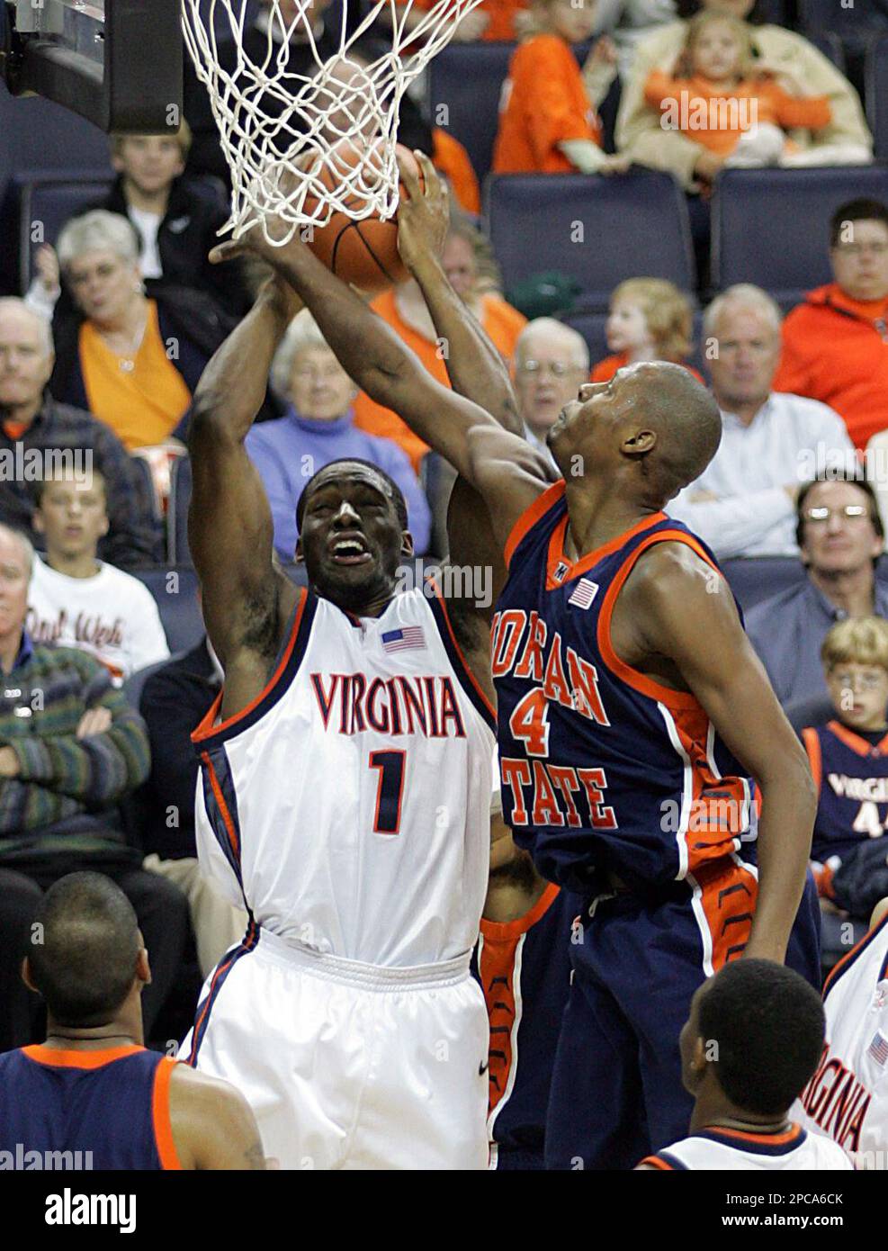 Virginia s Will Harris 1 is defended at the basket by Morgan State s Boubacar Coly during a basketball game Sunday Nov. 19 2006 in Charlottesville Va. Virginia won 85 66. AP Photo The Daily Progress A...