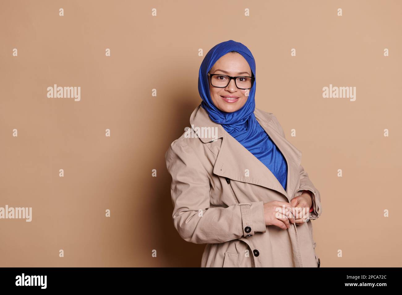Gorgeous middle-aged confident t Middle-Eastern Muslim woman in beige ...
