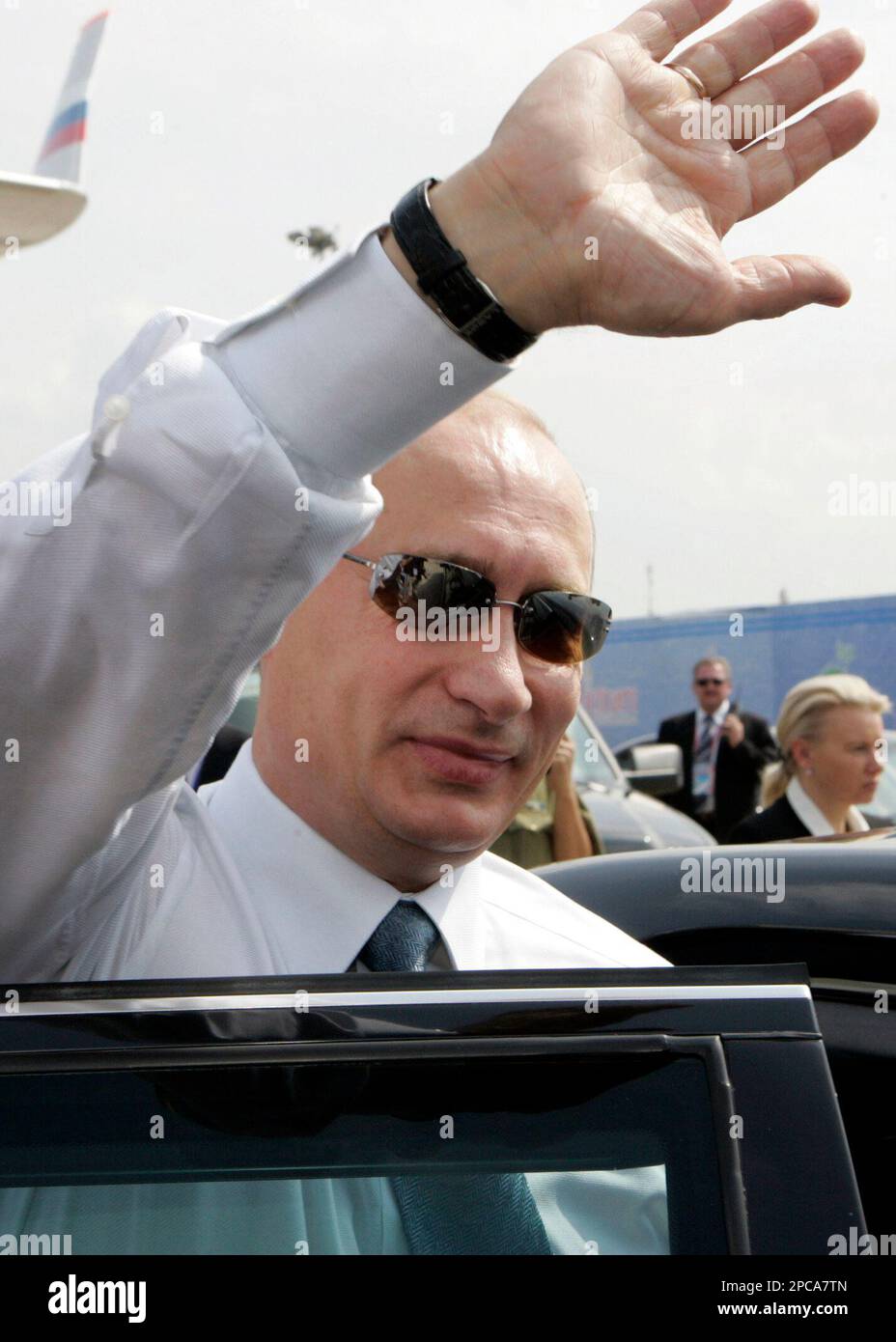 Russian President Vladimir Putin waves as he gets out of his limousine ...