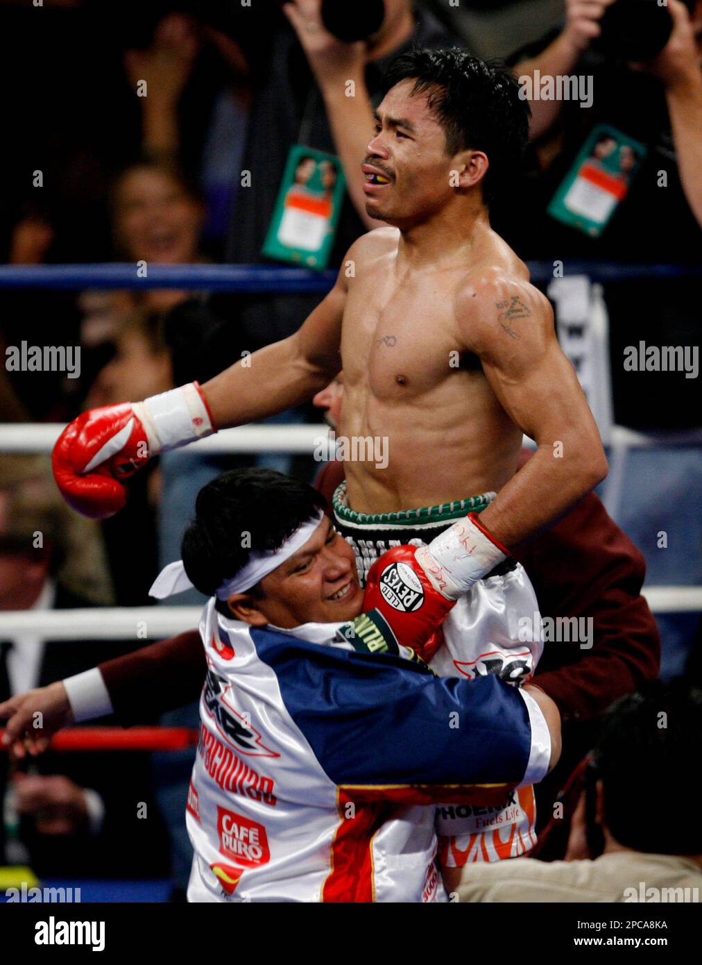 Manny Pacquiao, of the Philippines, is hoisted by a member of his team ...