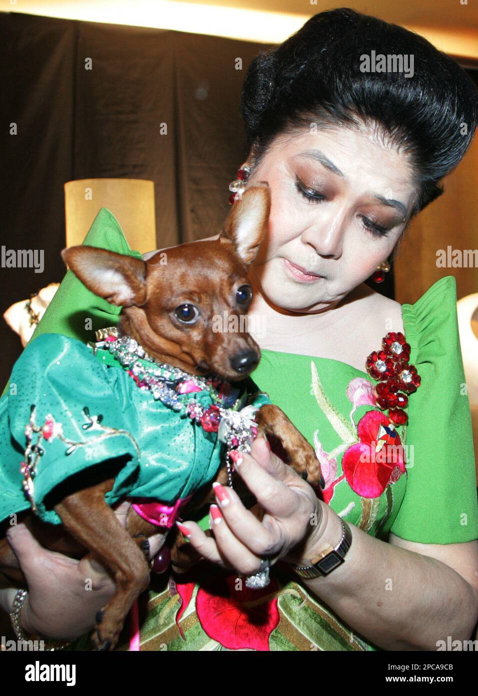 Former Philippine First Lady Imelda Marcos holds her jewelry-studded ...