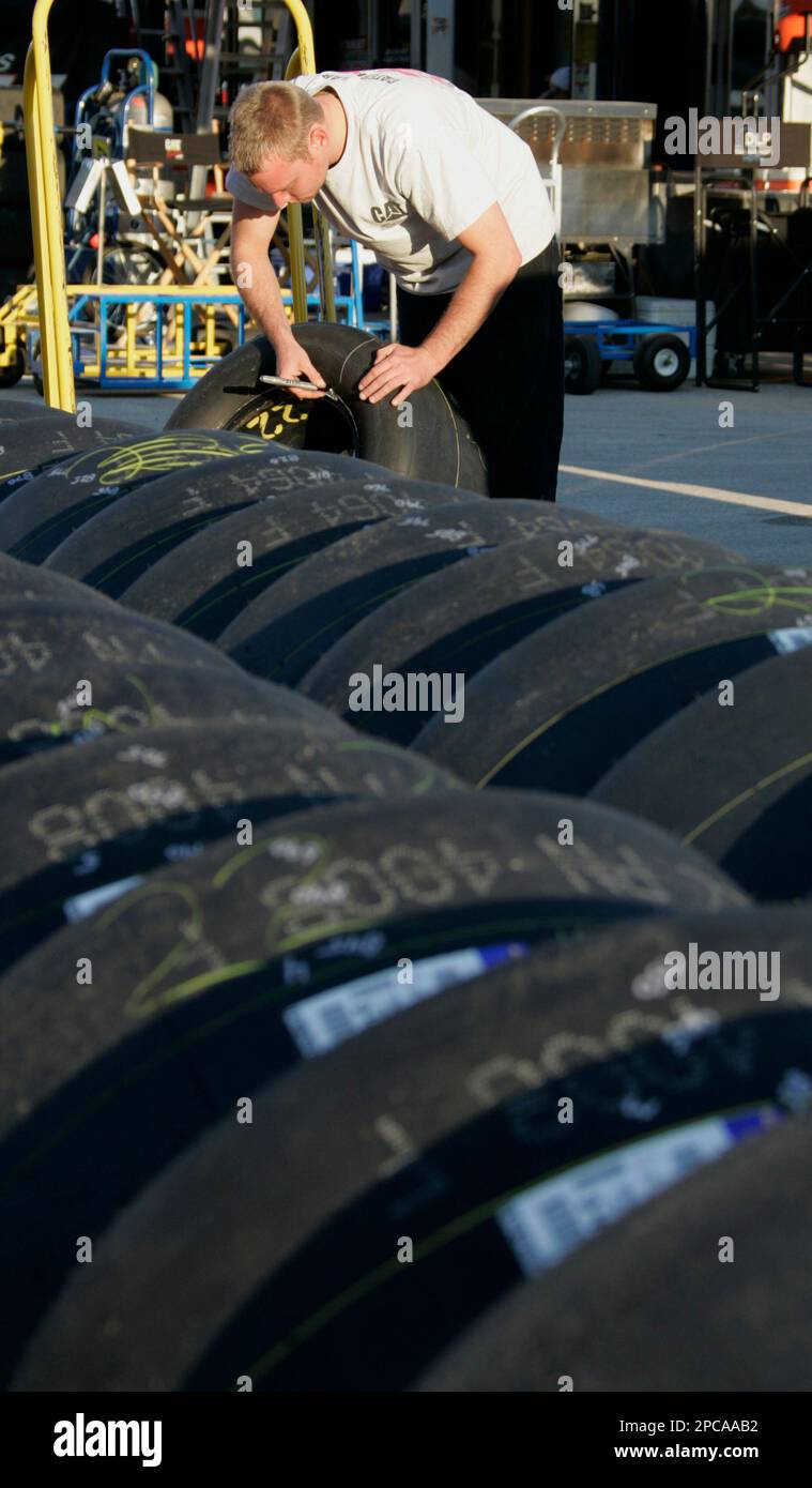 Kevin Gately, tire man of Bill Davis racing team checks tires after the ...
