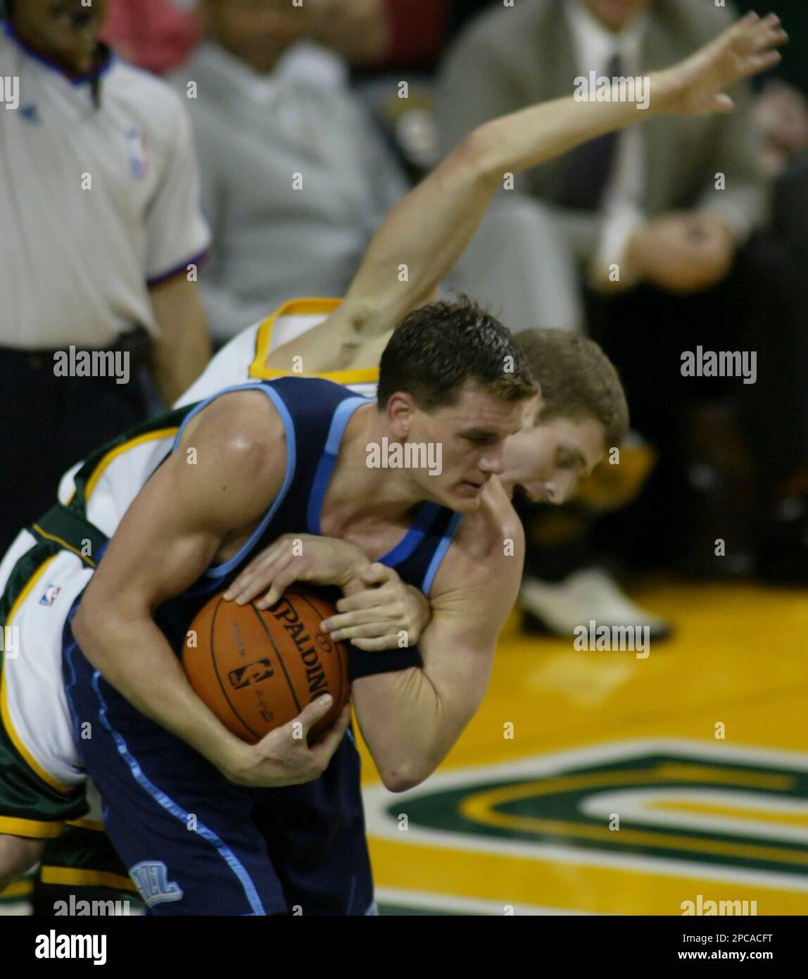 Utah Jazz' Matt Harpring , front, is fouled by Seattle SuperSonics ...